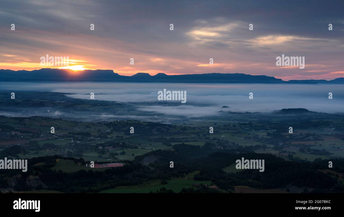 Foggy spring sunrise in Plana de Vic, seen from Sant Bartomeu del Grau ...