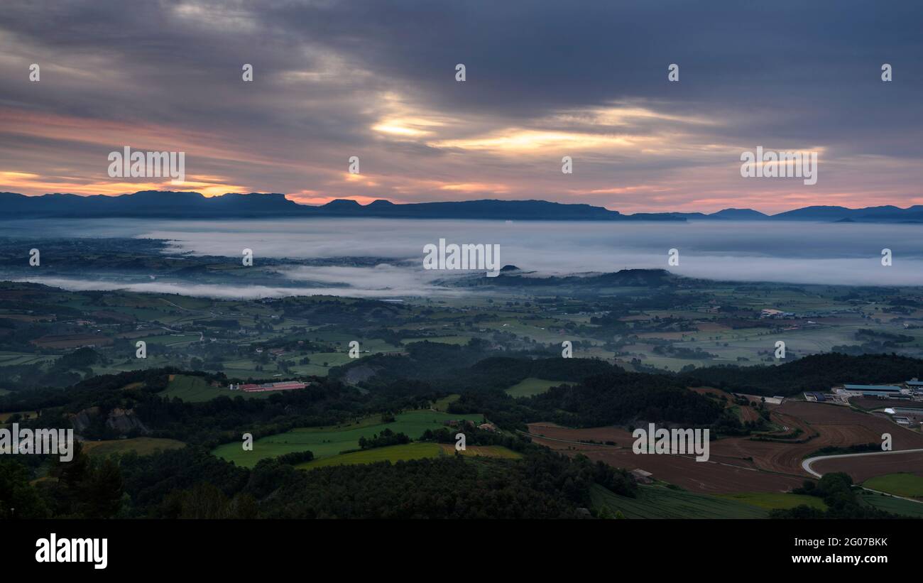 Foggy spring sunrise in Plana de Vic, seen from Sant Bartomeu del Grau ...