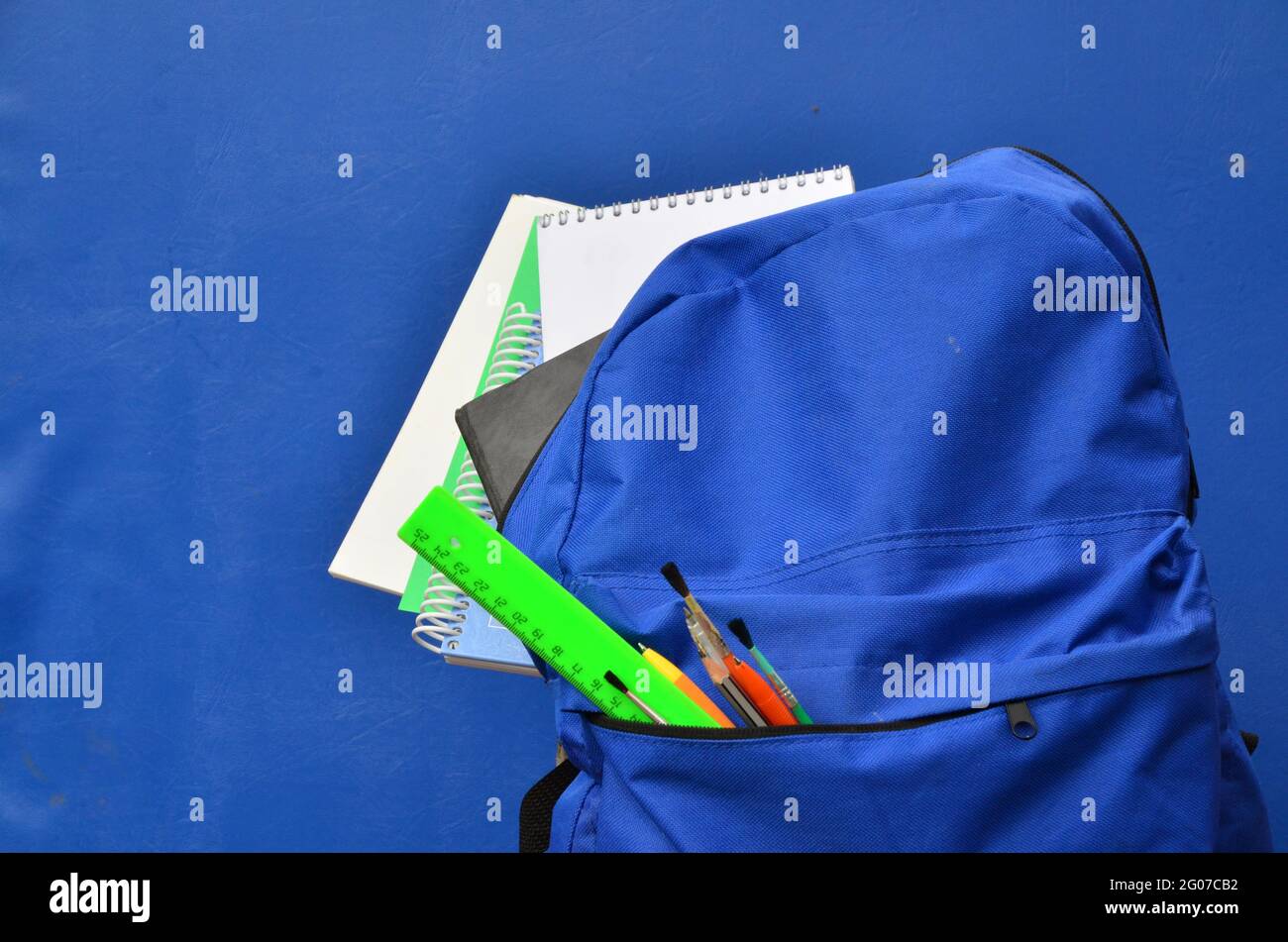 Full School backpack on wooden and nature background school supplies ...