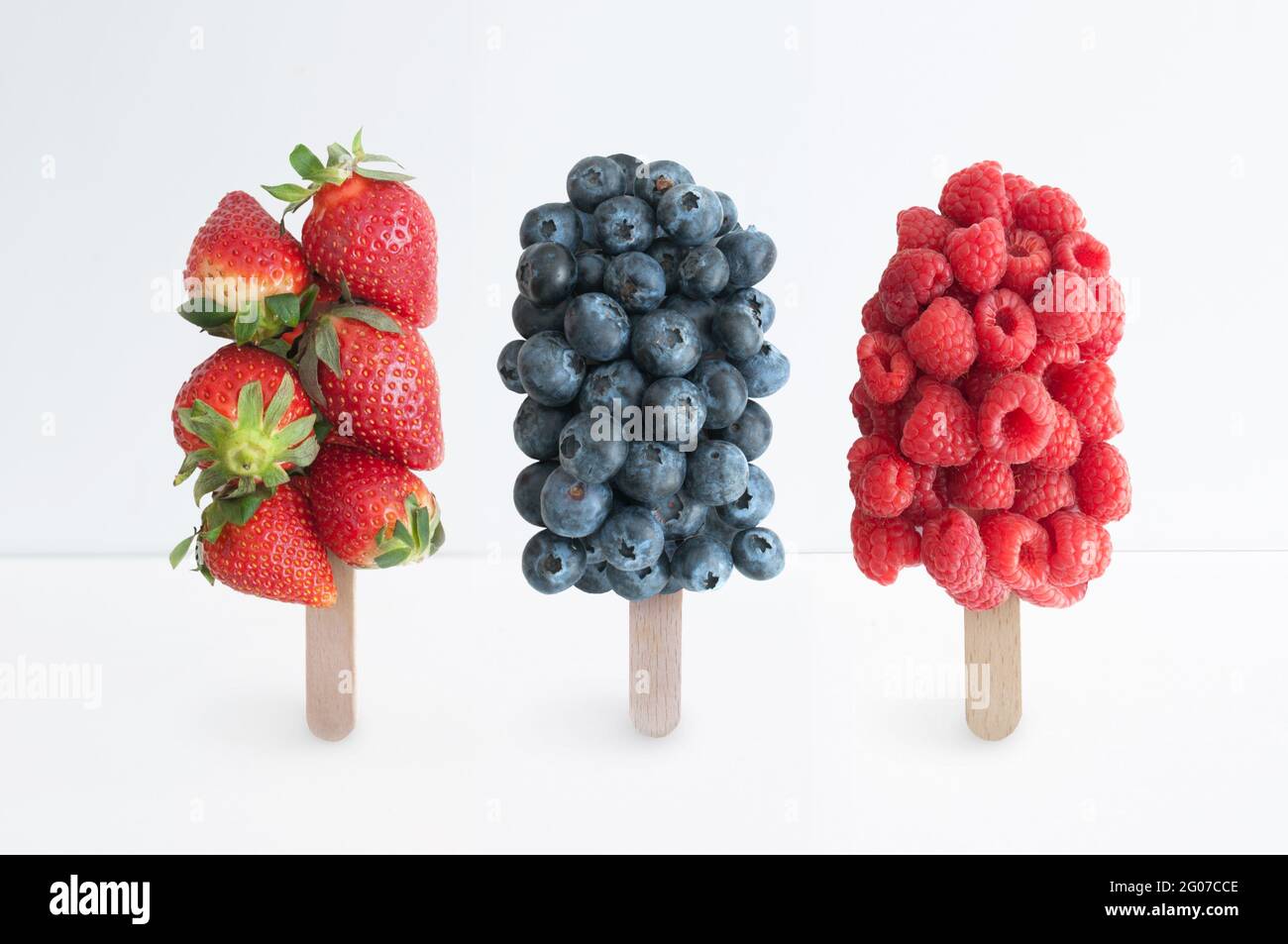Fruit berry flavoured ice lolly stick concept, strawberry, blueberry ...