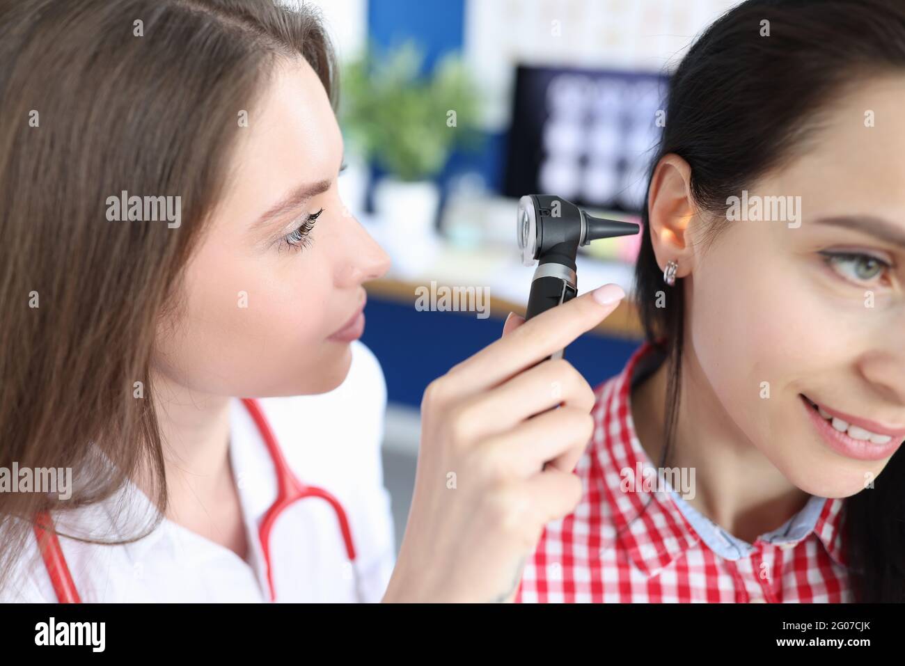 Otorhinolaryngologist examines patient ear with otoscope closeup Stock ...