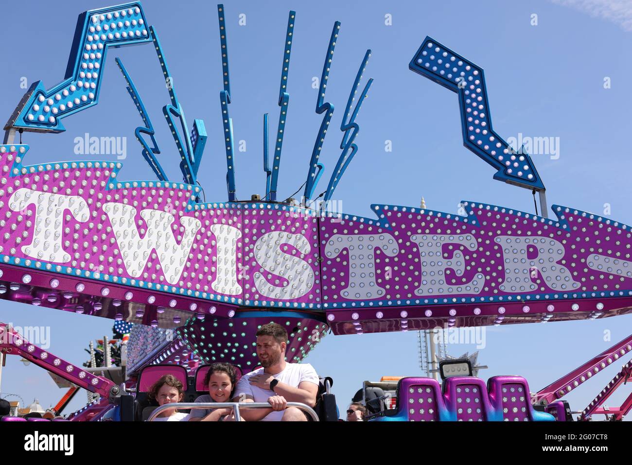 People seen on a ride at a fun fair in the UK Stock Photo - Alamy