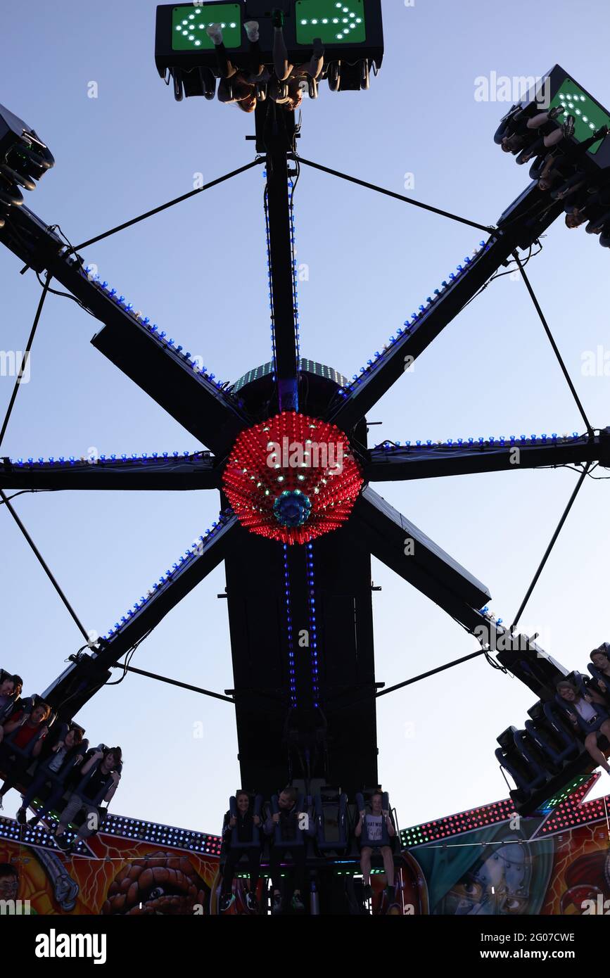 People seen on a ride at a fun fair in the UK Stock Photo - Alamy
