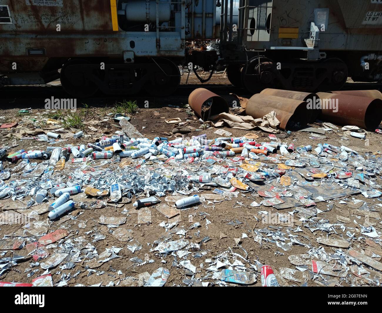 Old abandoned train station site with littered trash and metal tubes ...