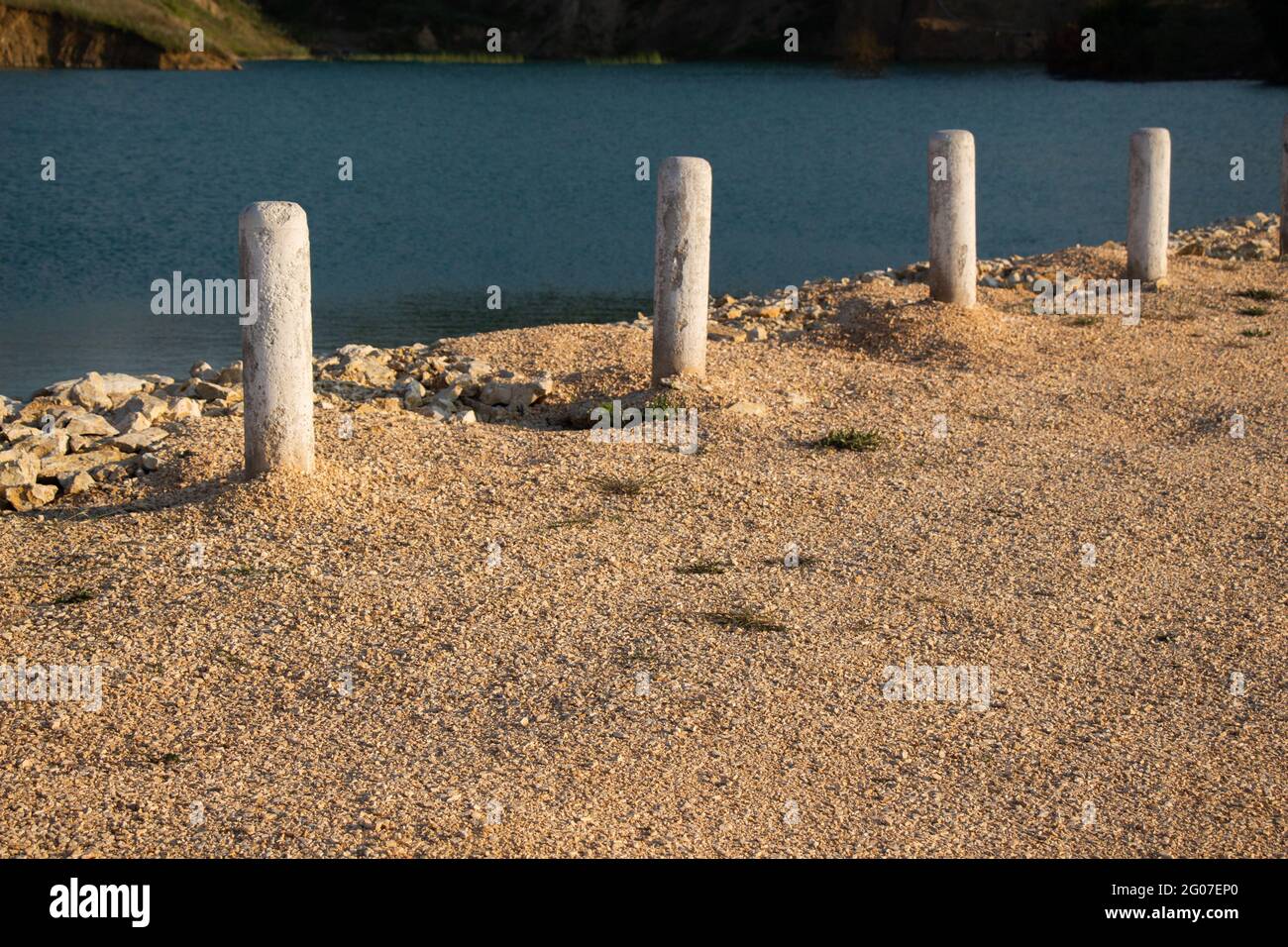 Closeup shot of wooden poles on a shore near a lake Stock Photo - Alamy