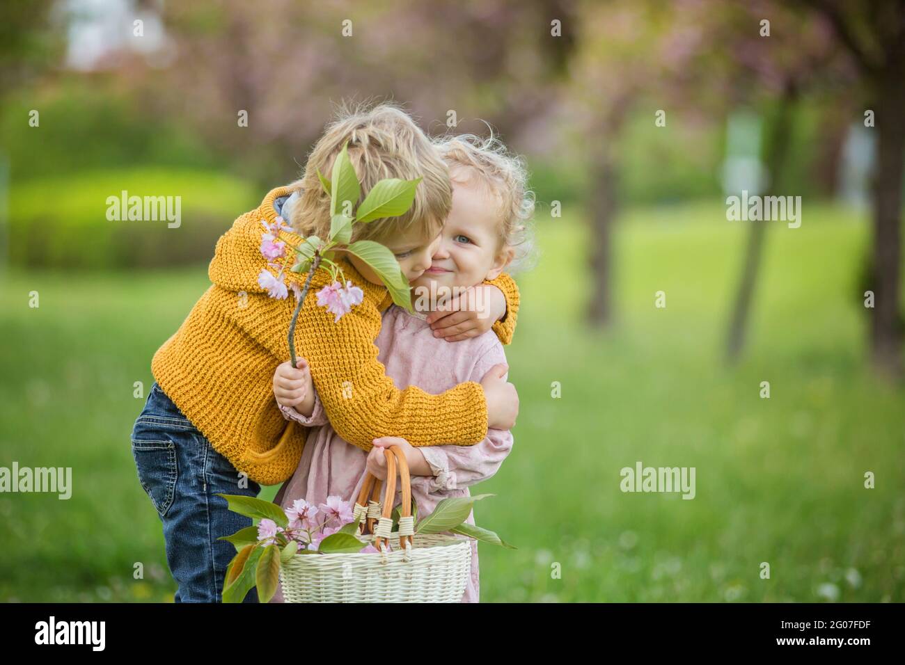 Beautiful children, toddler boy and girl, playing together in cherry ...