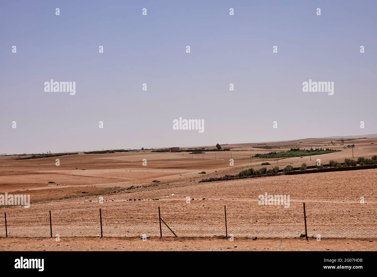 Horizontal background of a deserted land under a blue cloudless sky ...