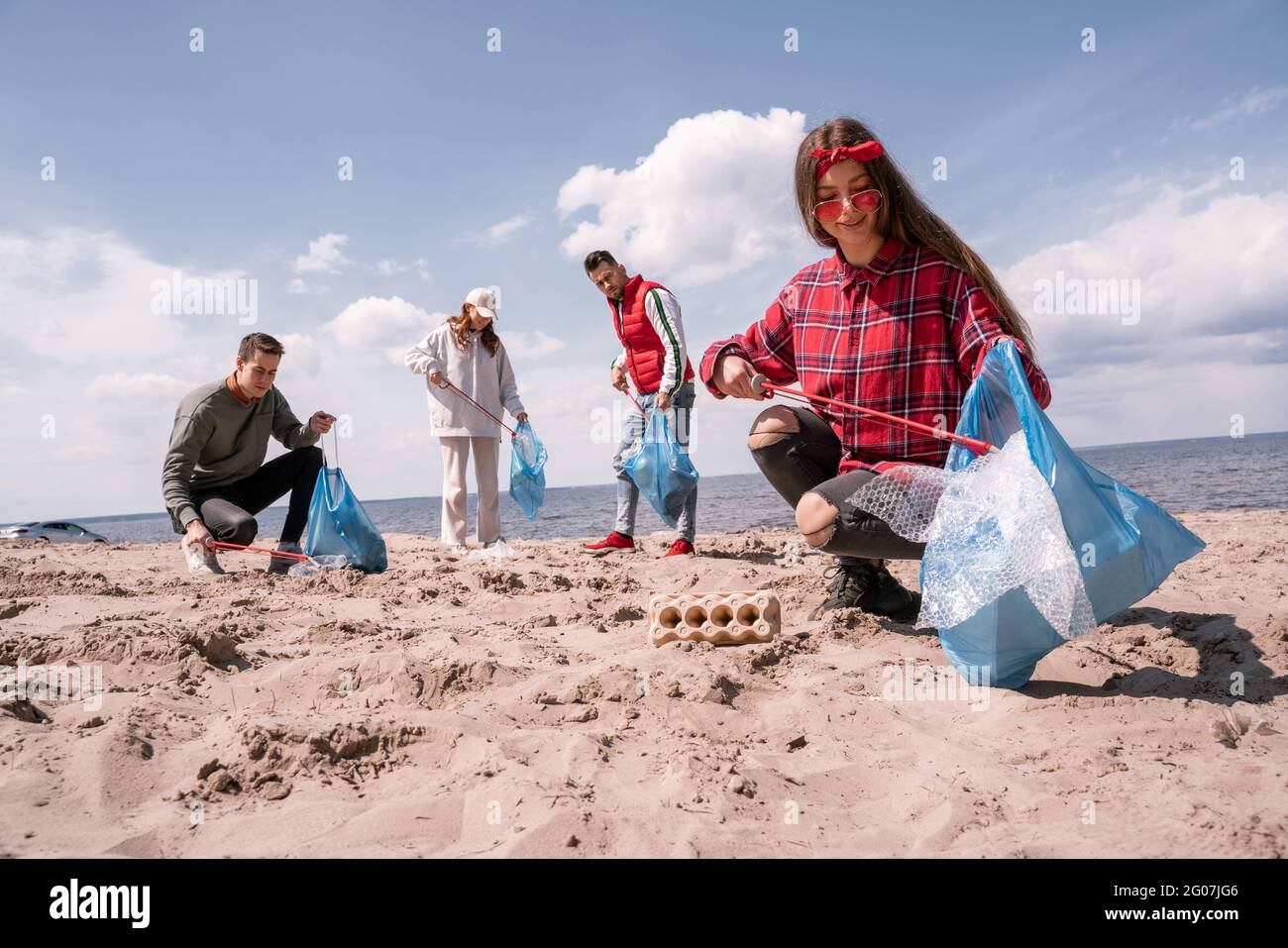 Young people collecting garbage hi-res stock photography and images - Alamy