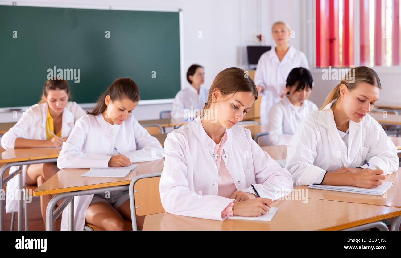 Medical students writing in notepads Stock Photo - Alamy