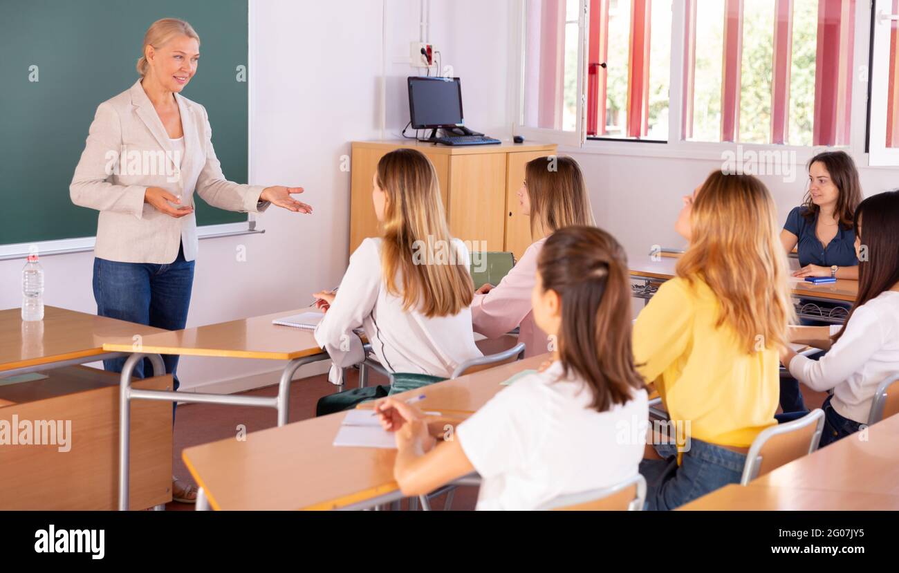 Female teacher lecturing to students Stock Photo - Alamy