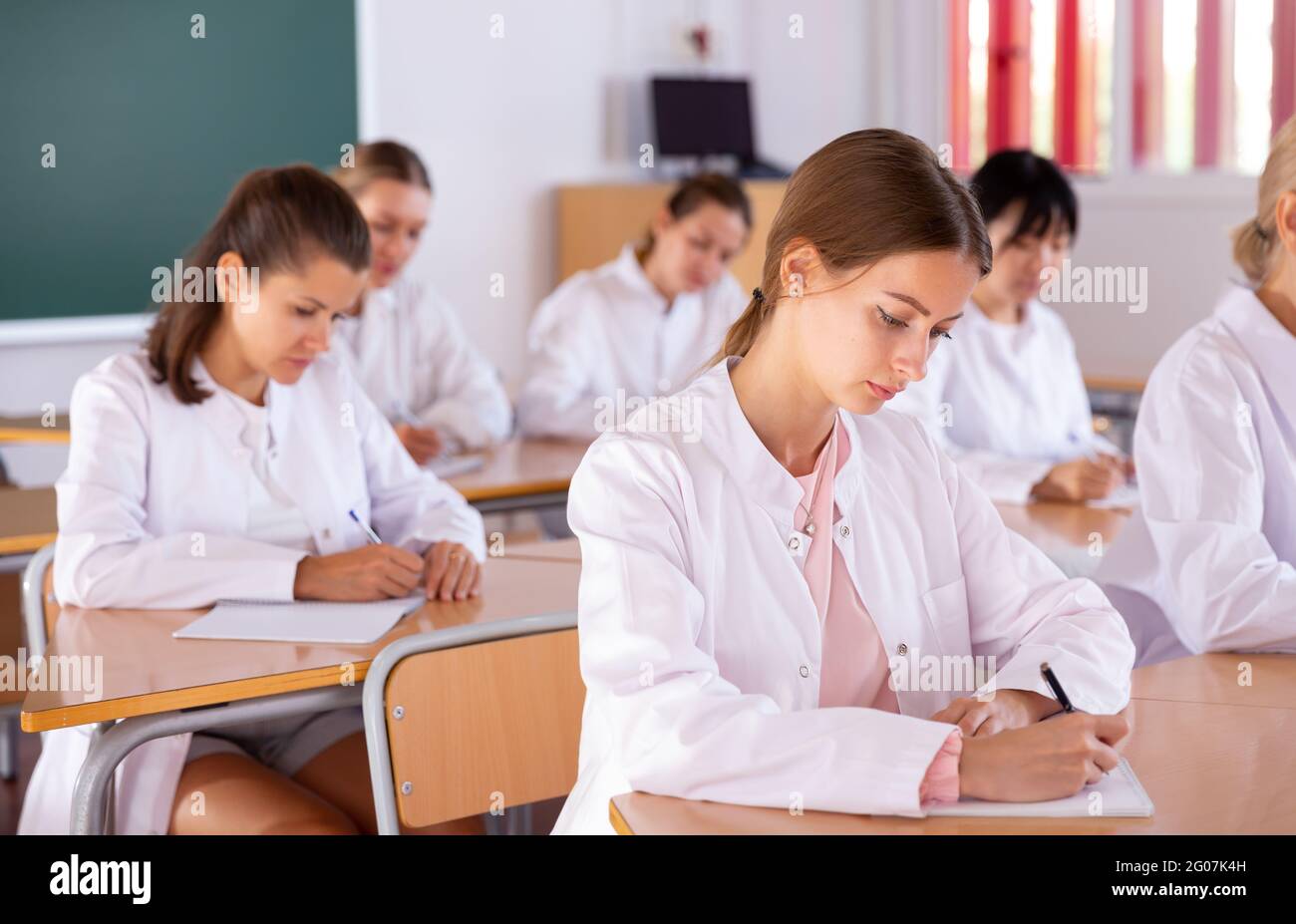 Medical students writing in notepads Stock Photo - Alamy