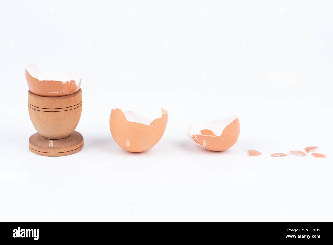 Horizontal shot of broken egg shell in old wooden egg stand and ...