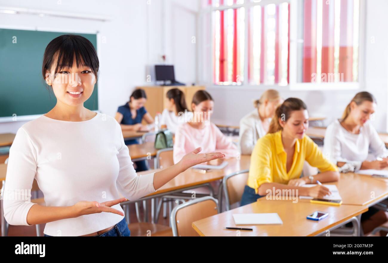 Asian female student standing in classroom Stock Photo - Alamy