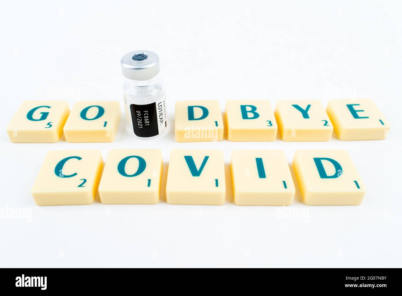 Yellow Scrabble letters saying GOODBYE COVID with the O letter replaced ...