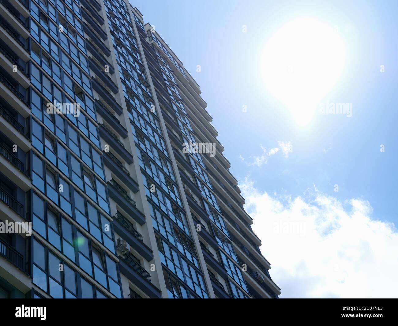 Multi-storey building with many glass windows standing against ...