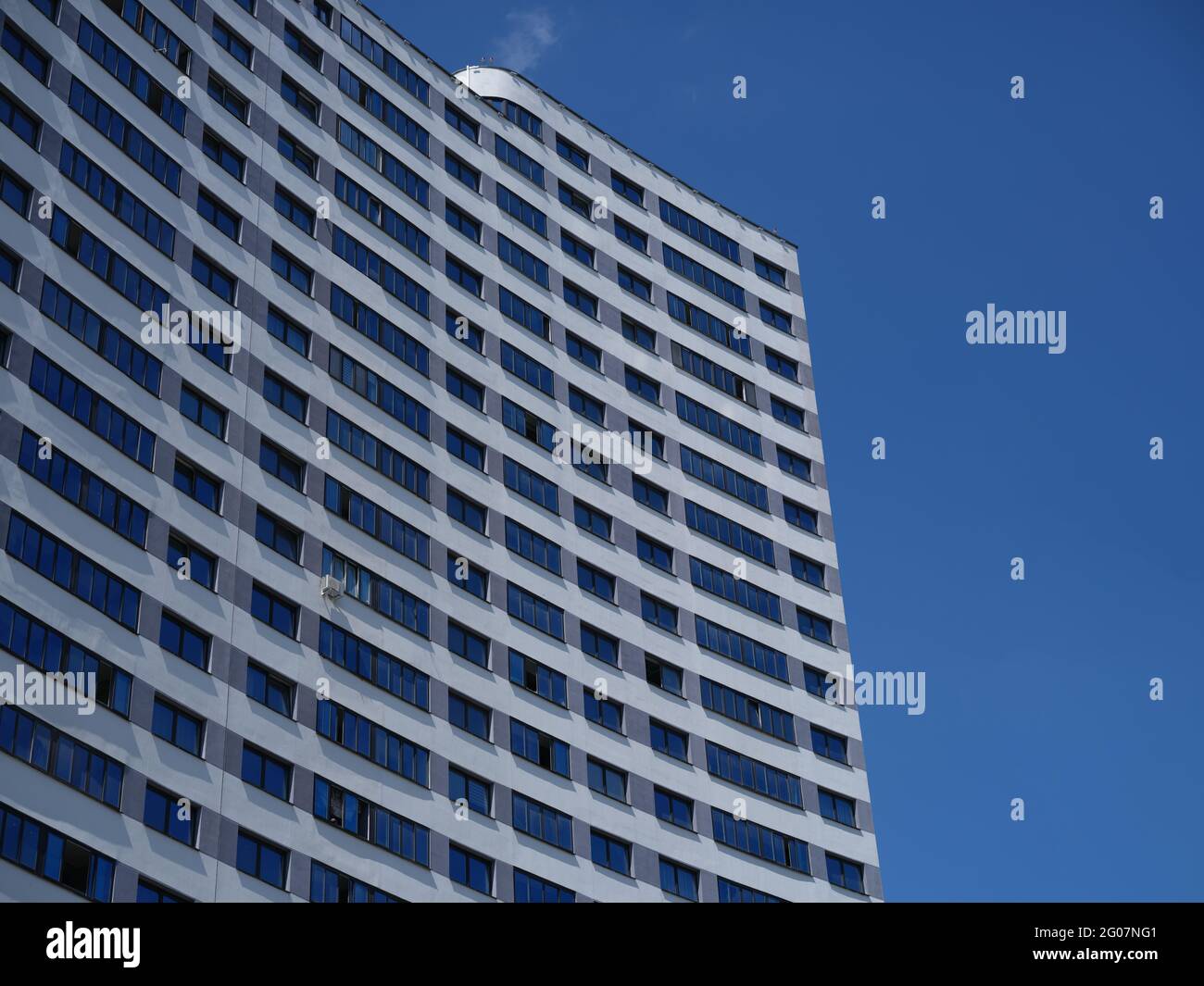 Beautiful multi-storey residential building standing against blue ...