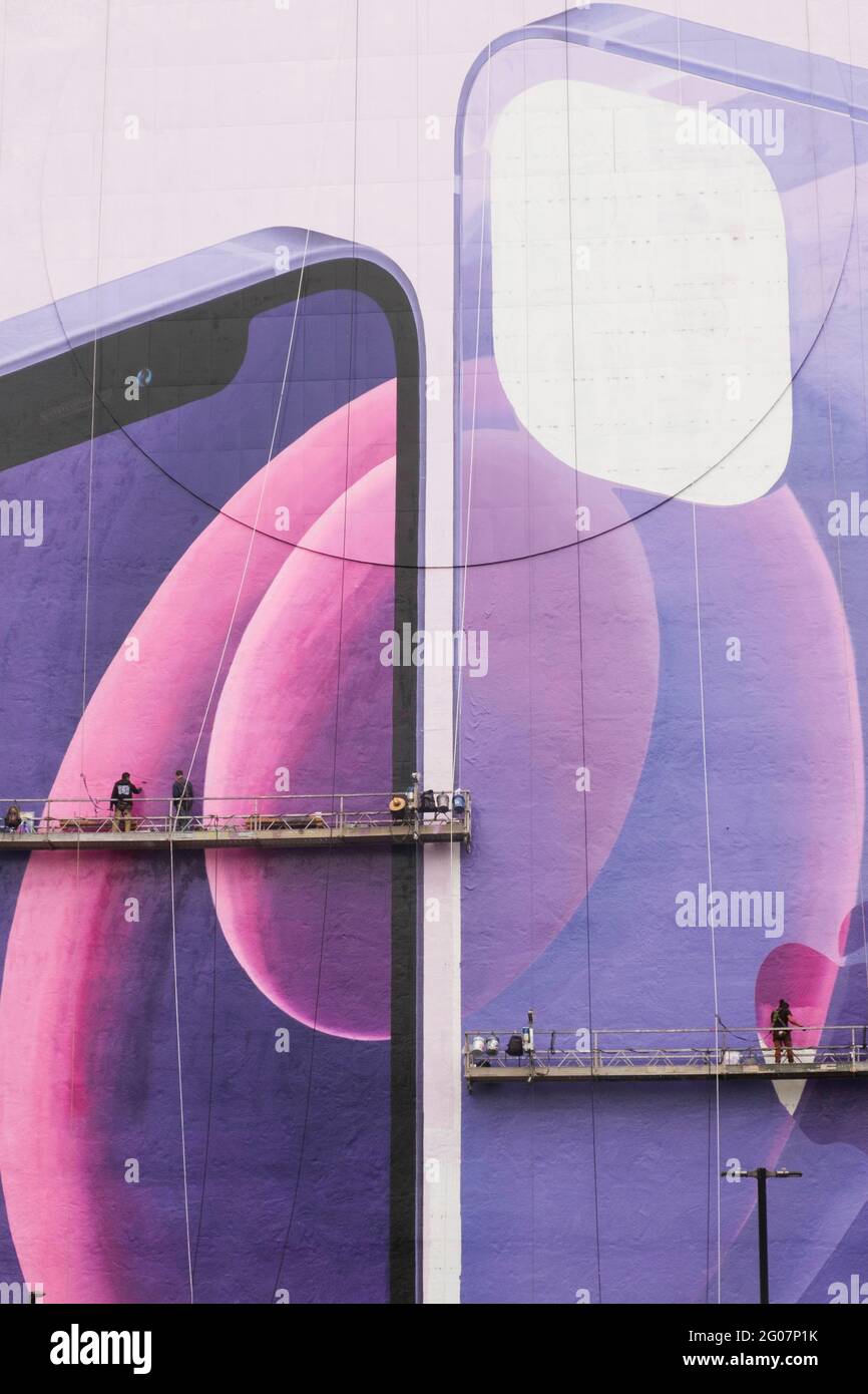 Workers painting an advertisement, downtown Los Angeles, California ...