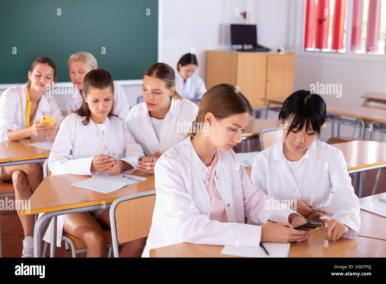 Medical students using phones in common research Stock Photo - Alamy