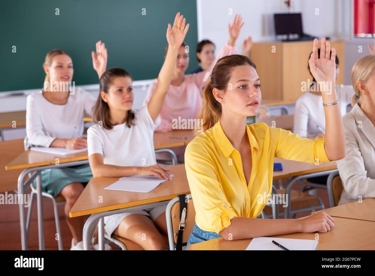 Students raising hands to answer Stock Photo - Alamy