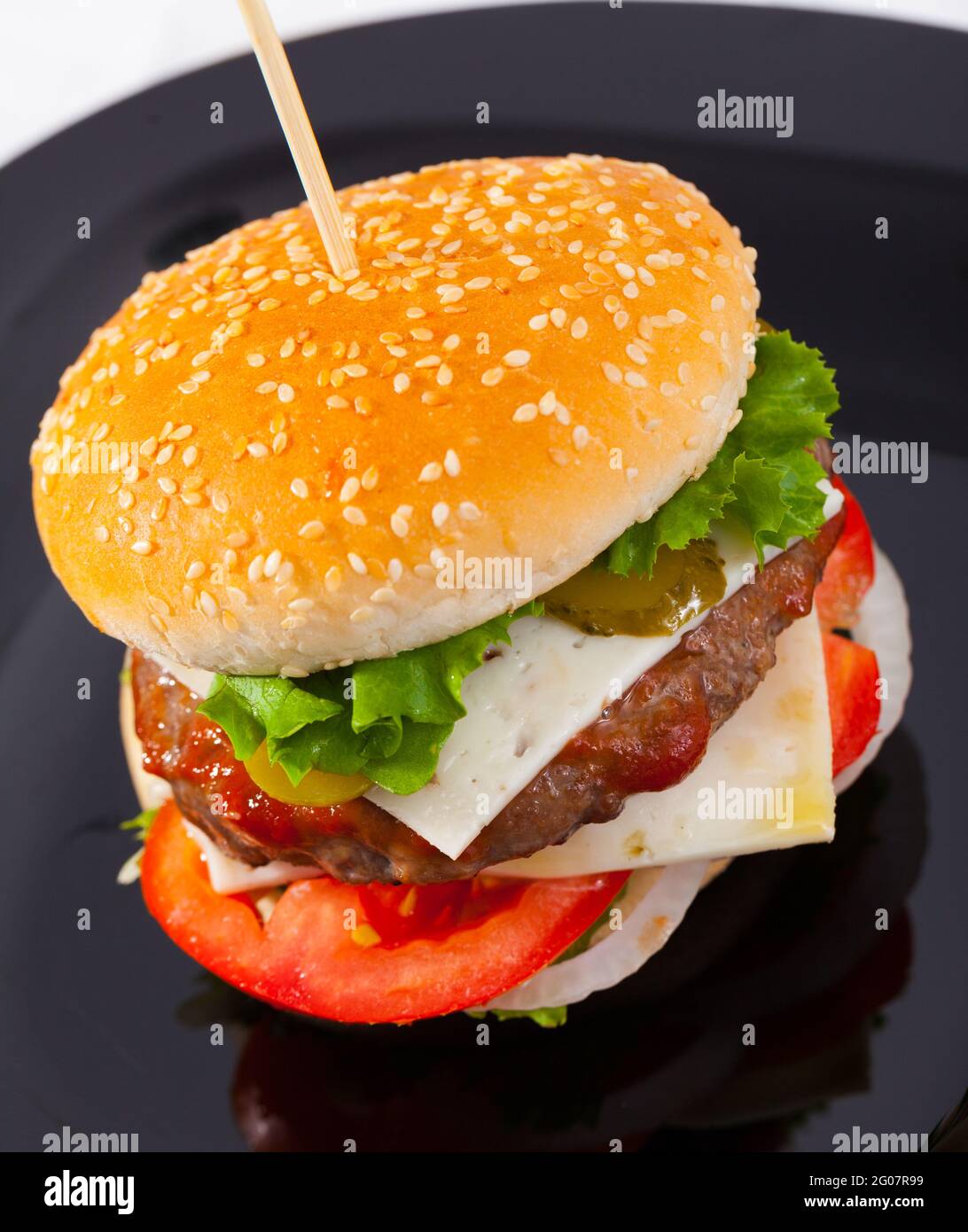 Grilled burger with beef, tomato, cheese, cucumber and lettuce Stock ...