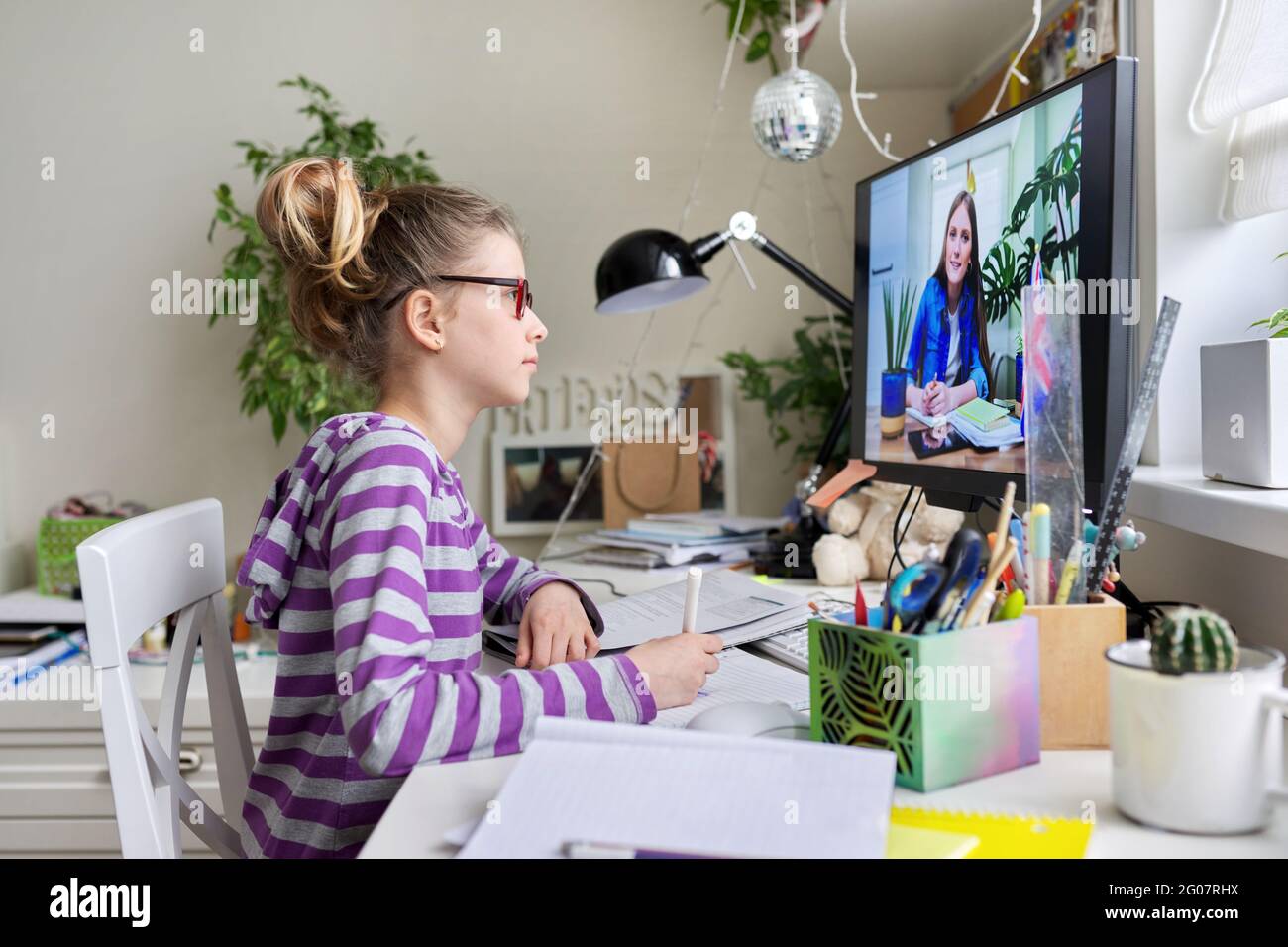 Girl child at home looking at computer monitor, talking learning ...
