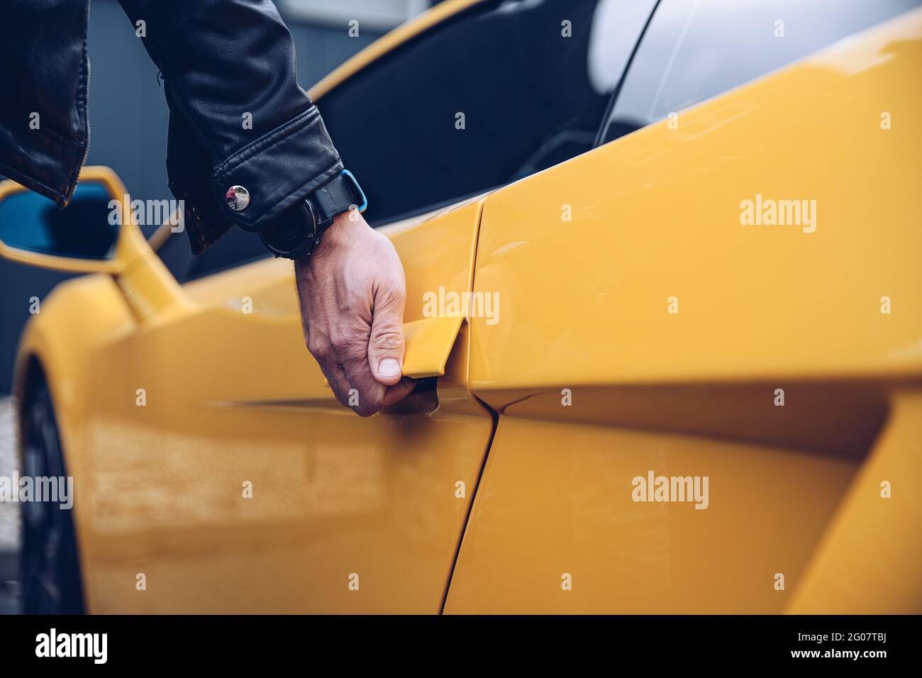 Man is reaching for the car door handle Stock Photo - Alamy
