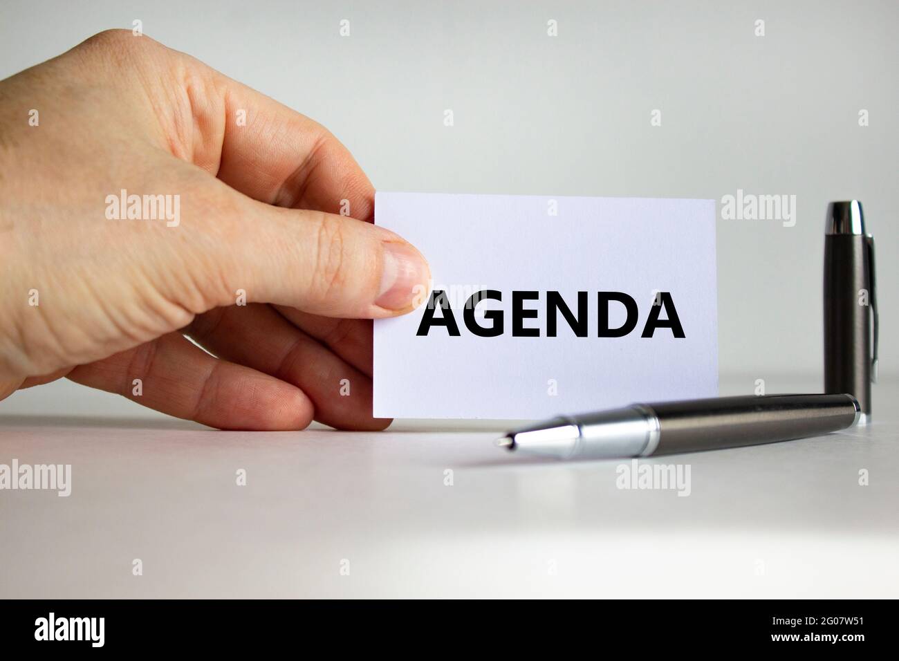 Agenda symbol. White paper with the word 'Agenda' in businessman hand ...