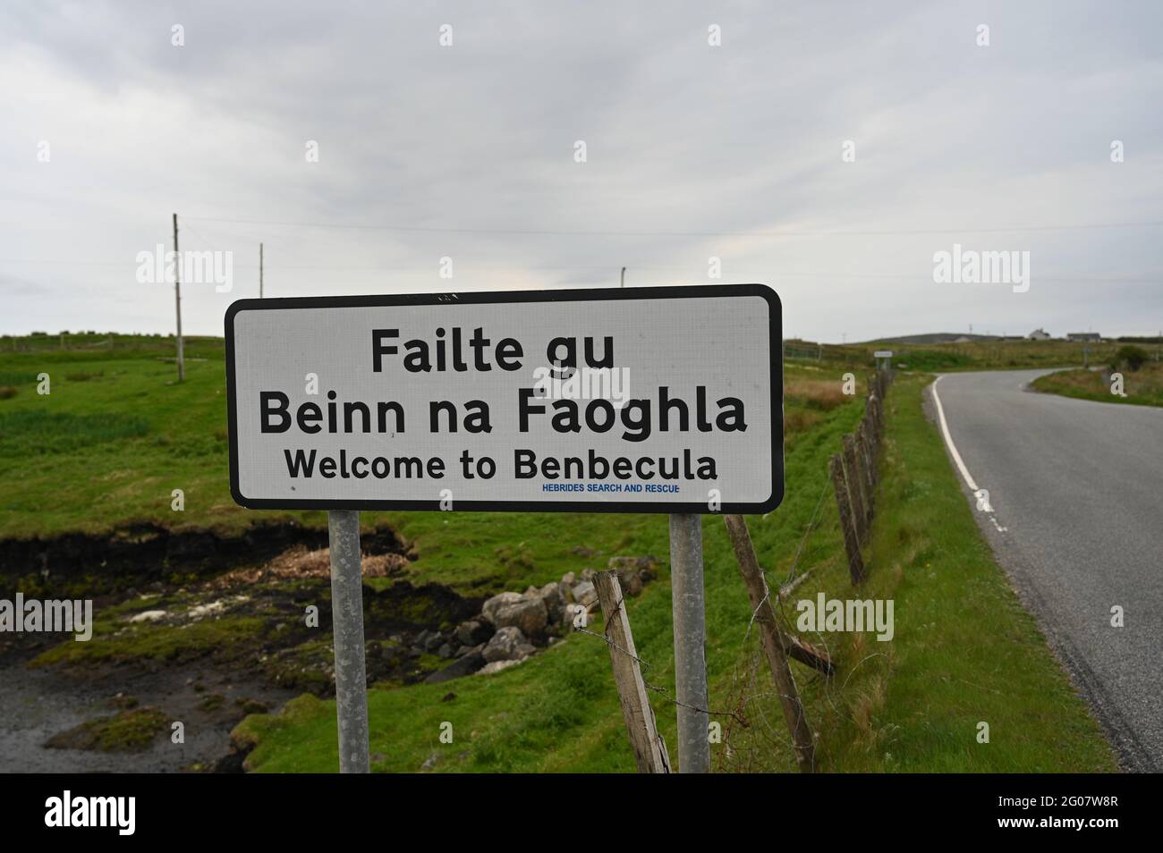 Welcome to Benbecula sign in English and Scottish Gaelic. Blurred rural ...
