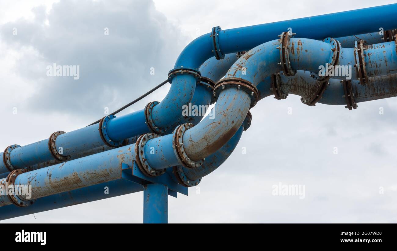 Composite of blue water pipes on a construction site Stock Photo - Alamy
