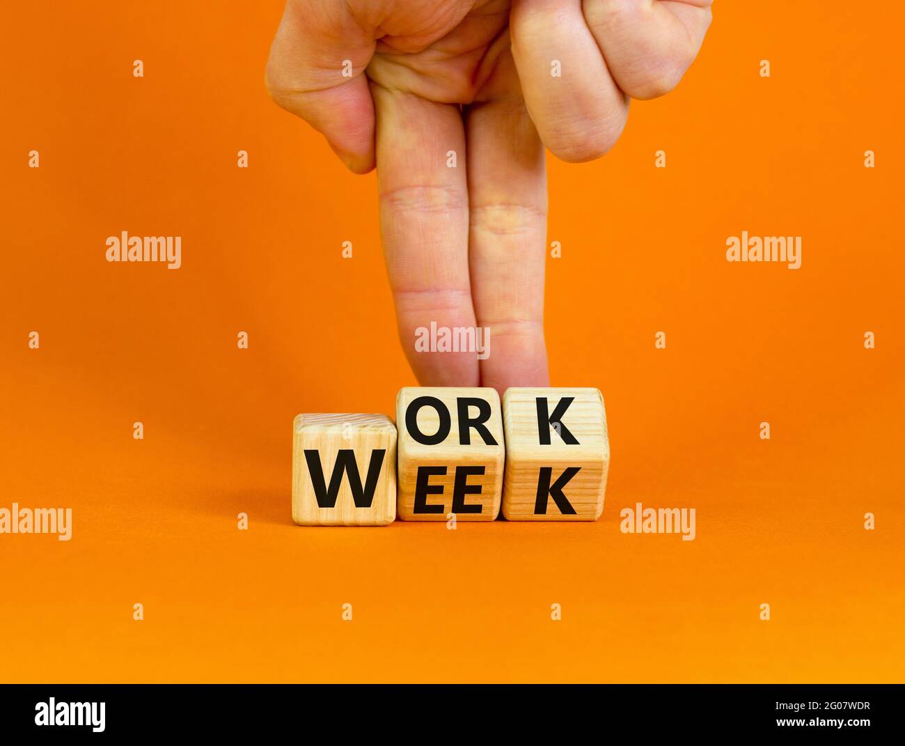 Work week symbol. Businessman turns wooden cubes with words 'Work week ...