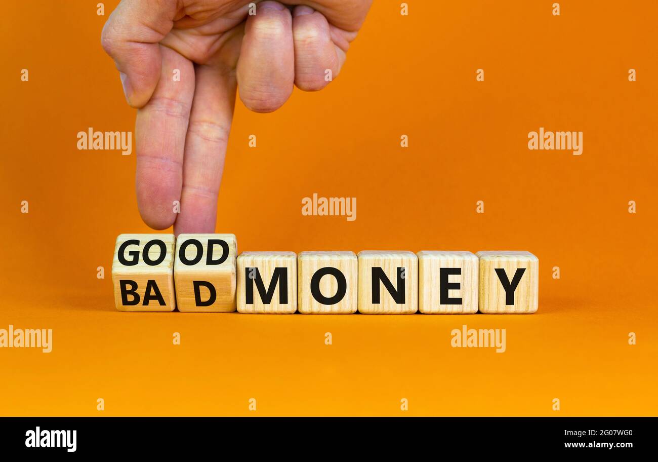 Good or bad money symbol. Businessman turns wooden cubes and changes ...