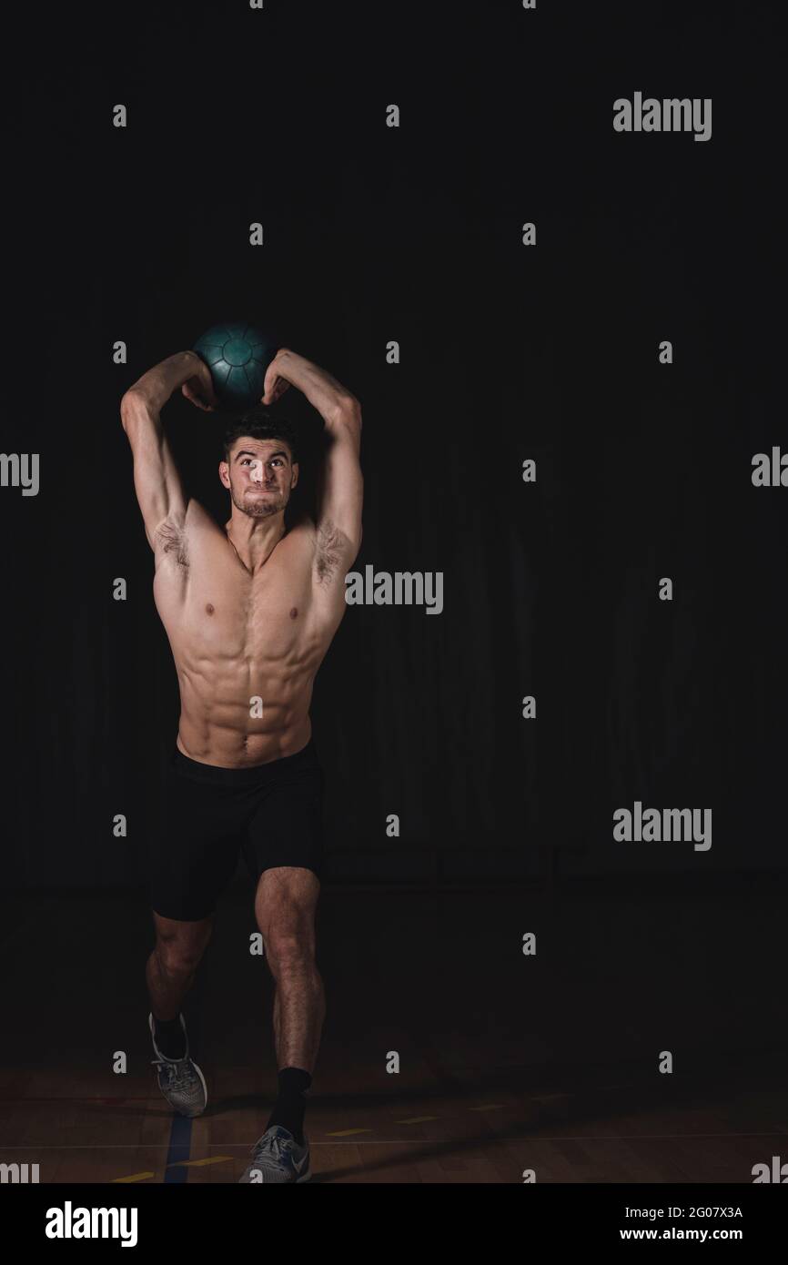 Fitness man working his muscles in the gym, it is his healthy and ...