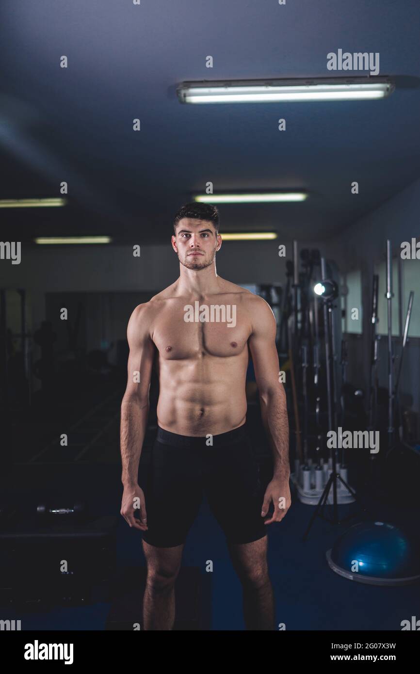 Fitness man working his muscles in the gym, it is his healthy and ...