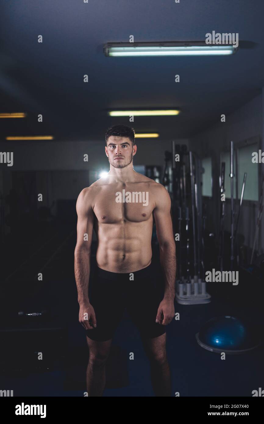 Fitness man working his muscles in the gym, it is his healthy and ...