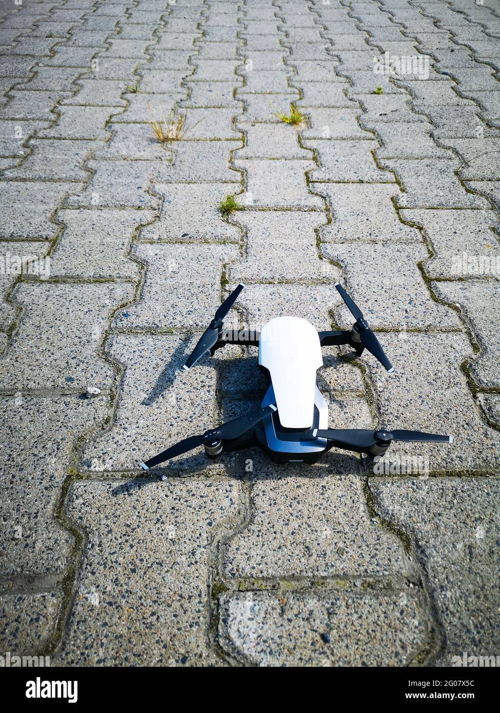 Small white drone on big H on helipad Stock Photo - Alamy