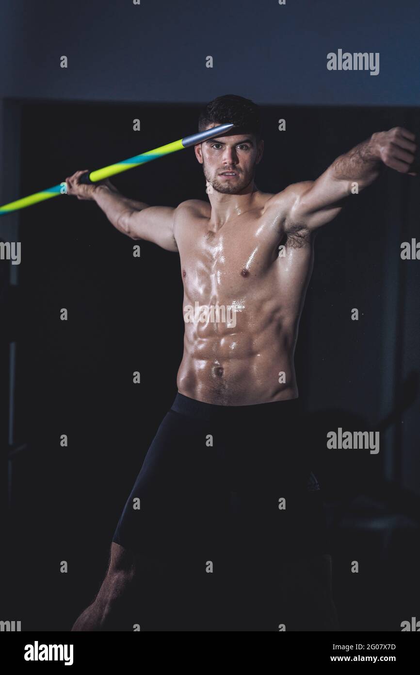 Fitness man working his muscles in the gym, it is his healthy and ...