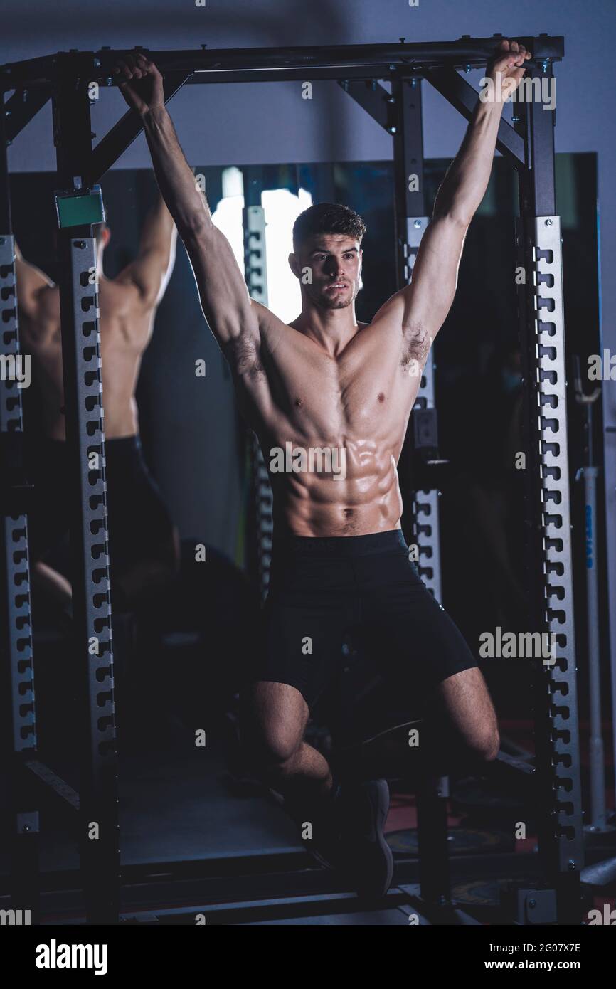 Fitness man working his muscles in the gym, it is his healthy and ...