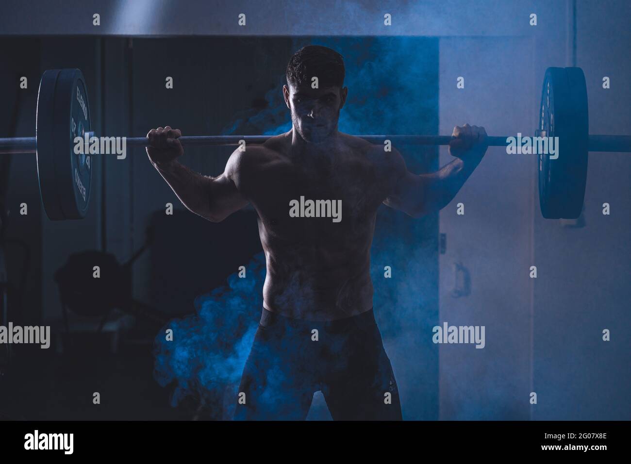 Fitness man working his muscles in the gym, it is his healthy and ...
