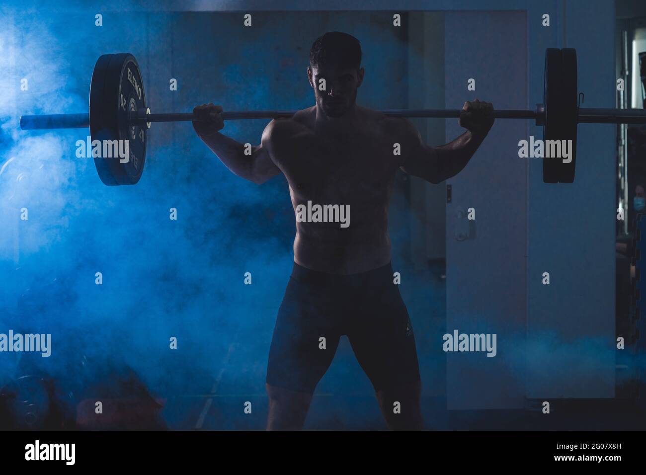 Fitness man working his muscles in the gym, it is his healthy and ...