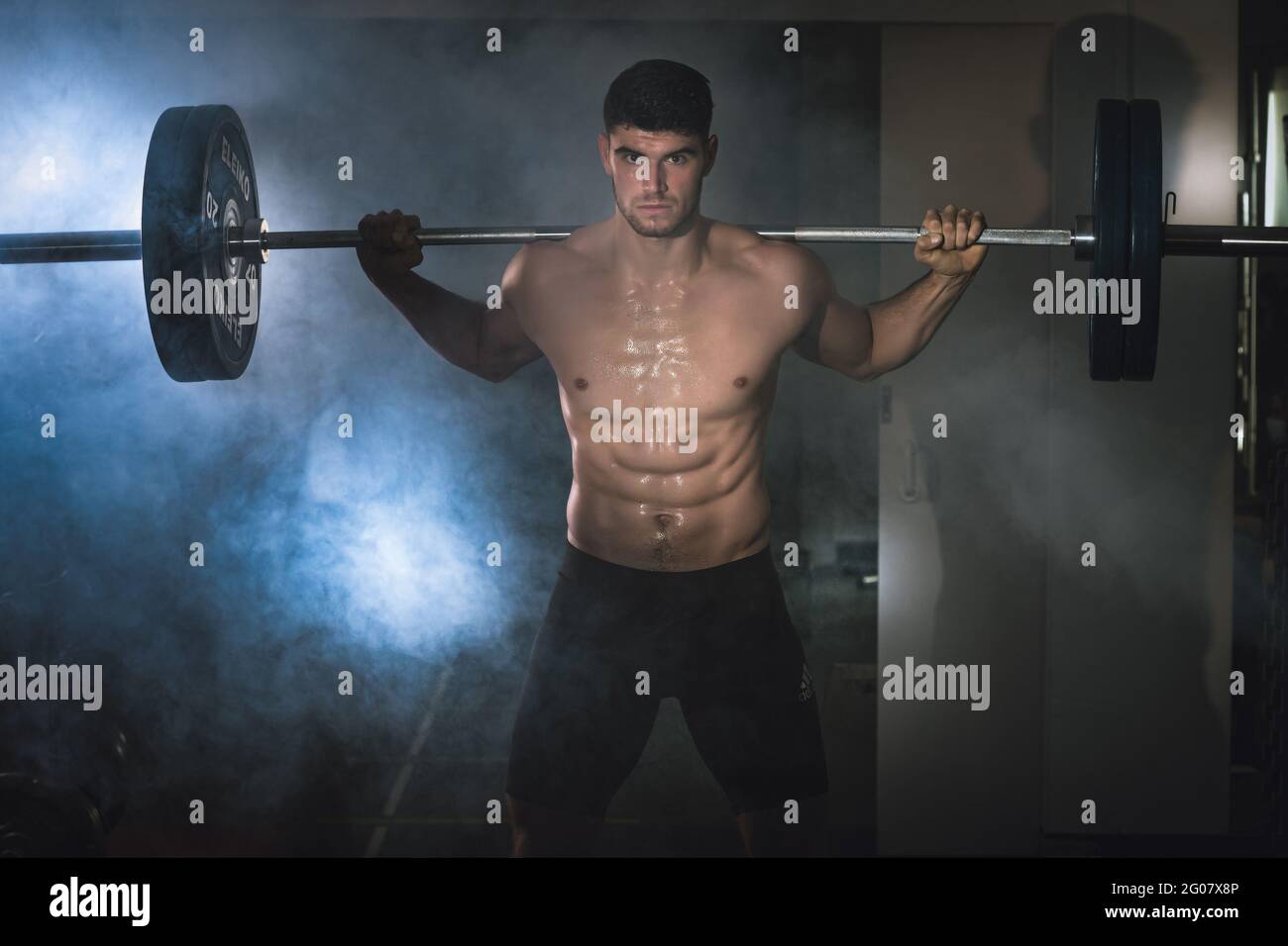 Fitness man working his muscles in the gym, it is his healthy and ...