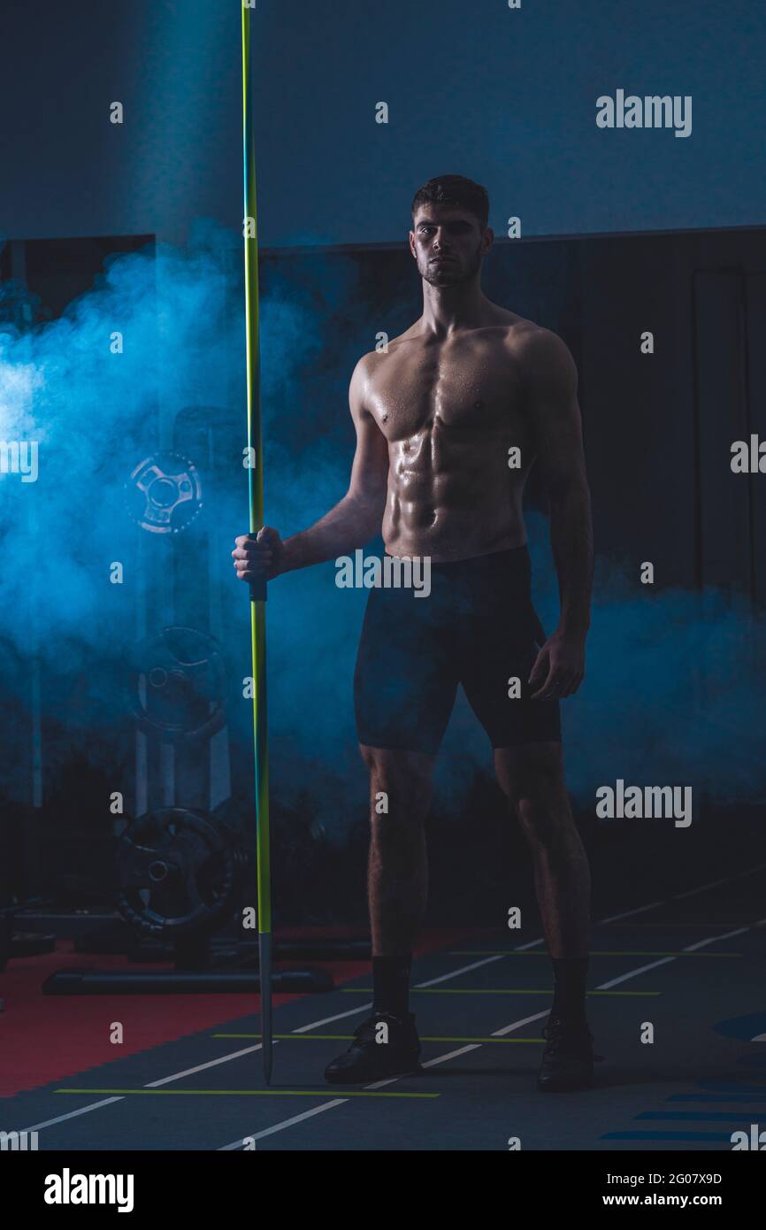 Fitness man working his muscles in the gym, it is his healthy and ...