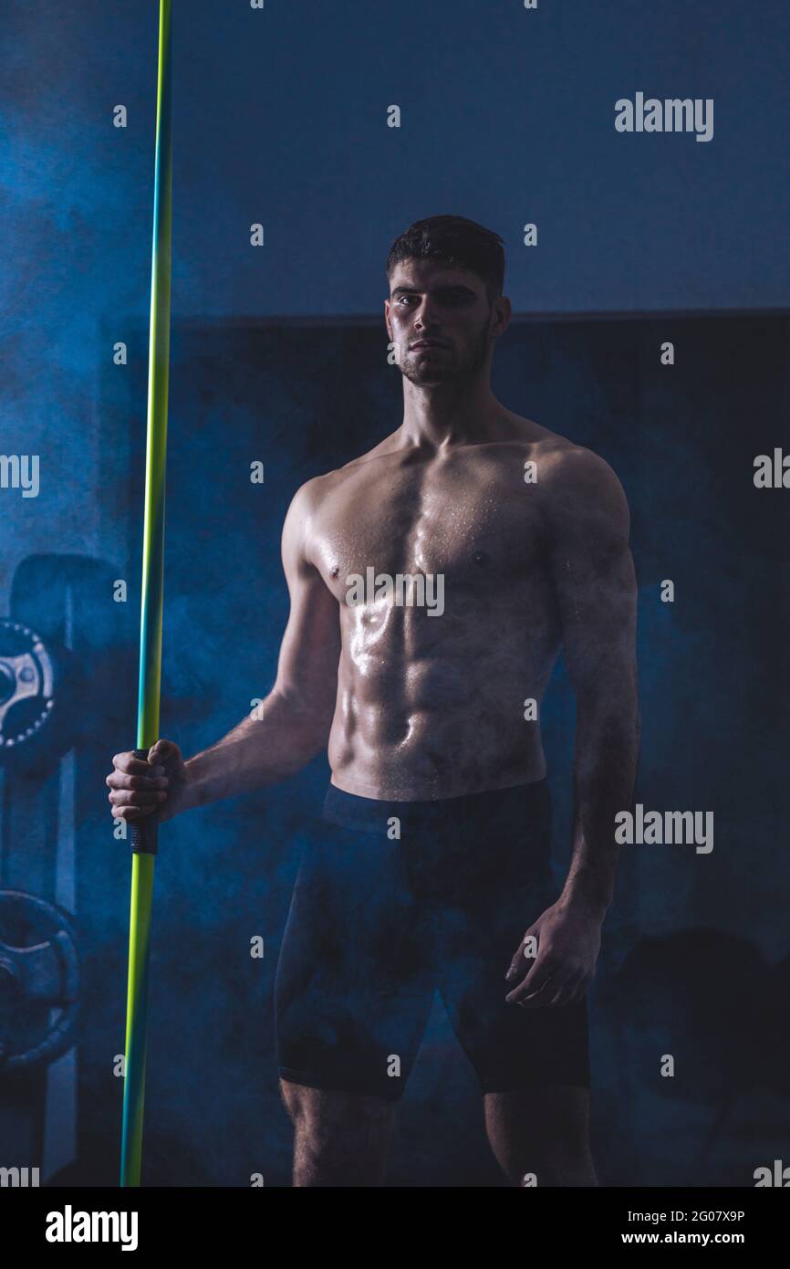 Fitness man working his muscles in the gym, it is his healthy and ...