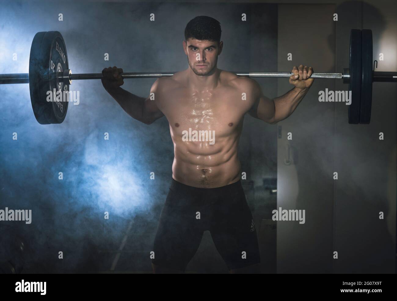 Fitness man working his muscles in the gym, it is his healthy and ...