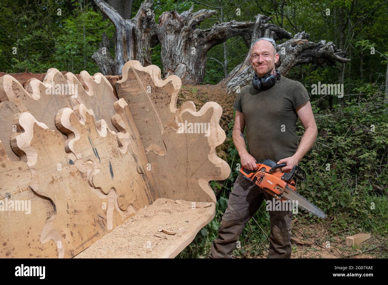 Matt Crabb, national chainsaw carving champion sculpting a bench out of ...