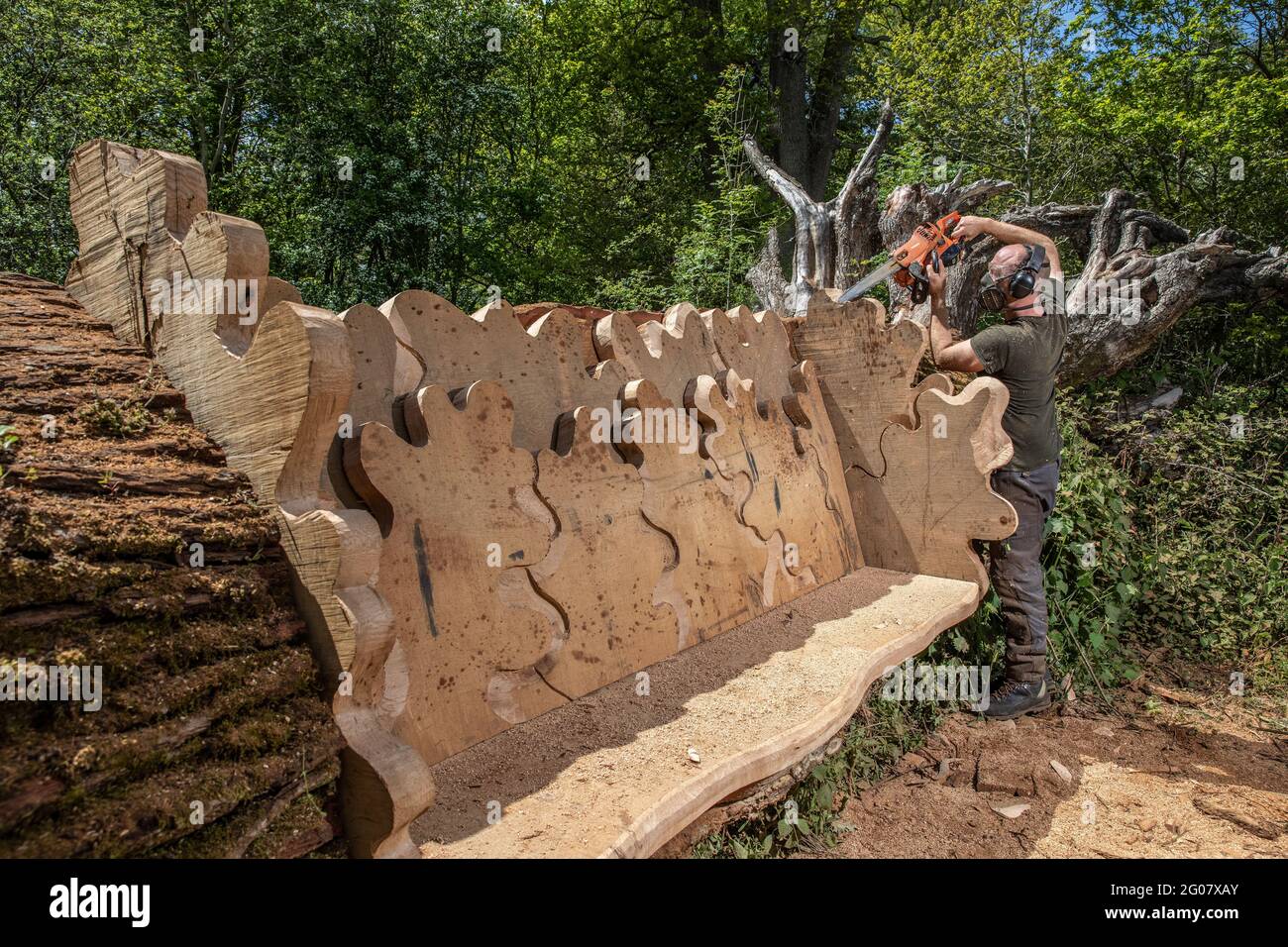 Matt Crabb, national chainsaw carving champion sculpting a bench out of ...