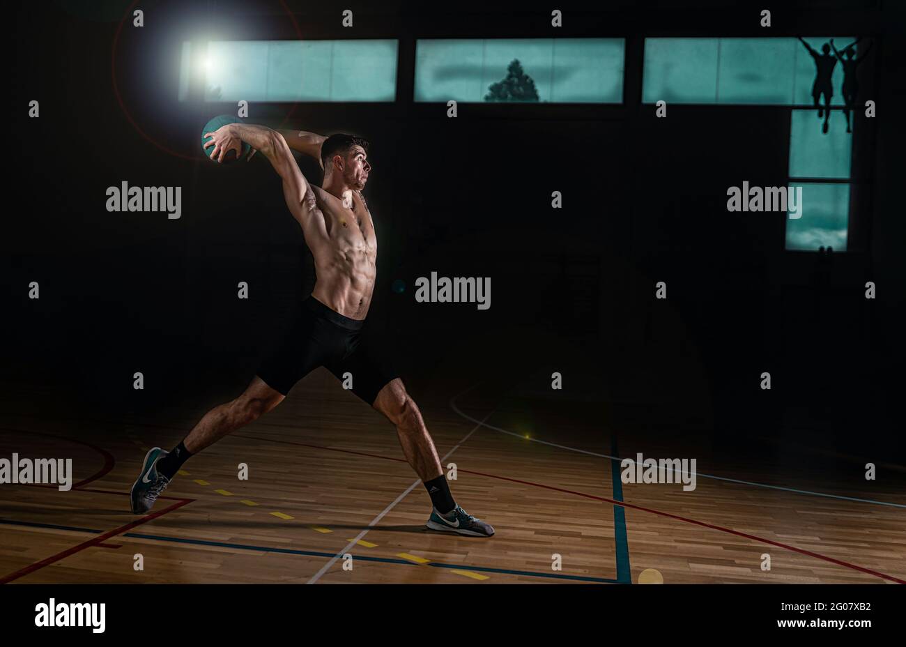 Fitness man working his muscles in the gym, it is his healthy and ...