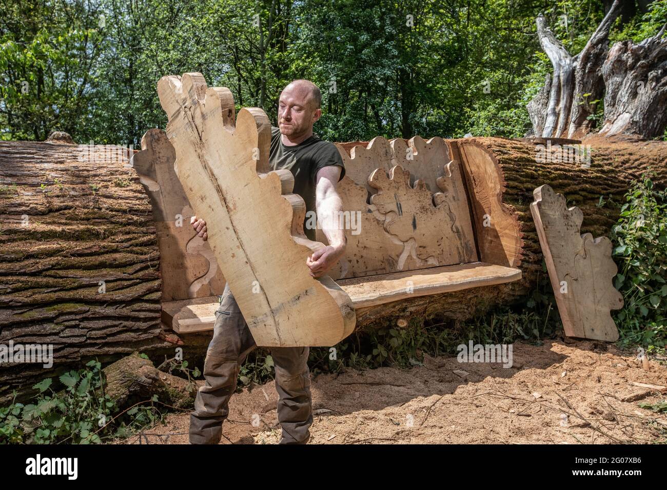Matt Crabb, national chainsaw carving champion sculpting a bench out of ...