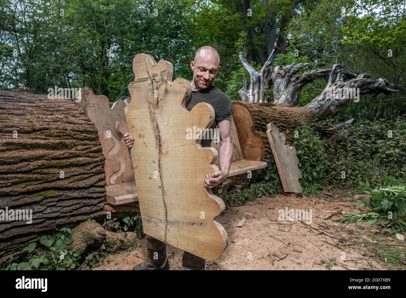 Matt Crabb, national chainsaw carving champion sculpting a bench out of ...
