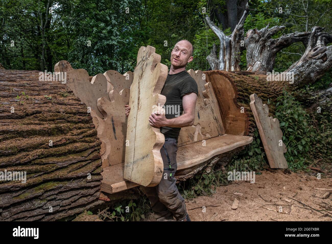 Matt Crabb, national chainsaw carving champion sculpting a bench out of ...