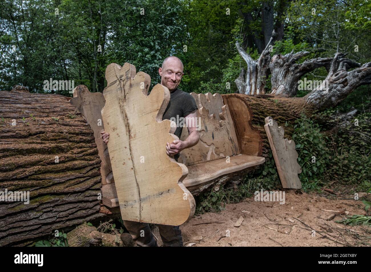 Matt Crabb, national chainsaw carving champion sculpting a bench out of ...